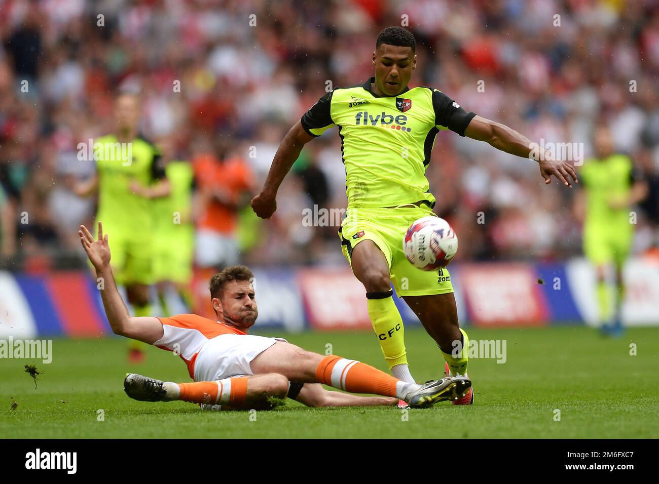Ollie Watkins of Exeter City looks to get past Clark Robertson of ...