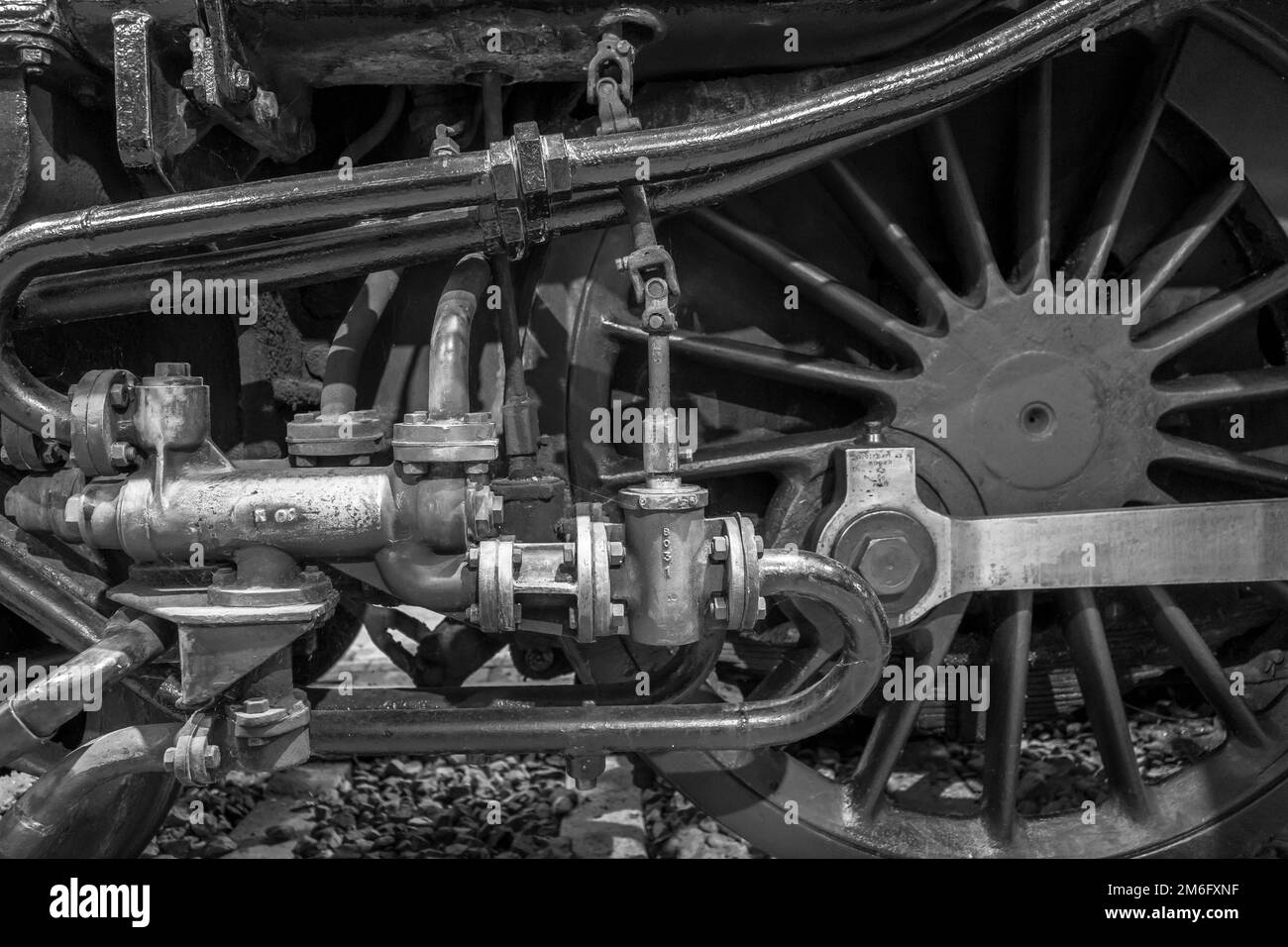 Black and white, close side view of an old, vintage UK steam locomotive ...
