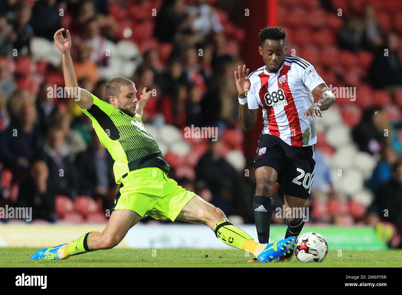 Joey van den Berg of Reading tackles Josh Clarke of Brentford ...