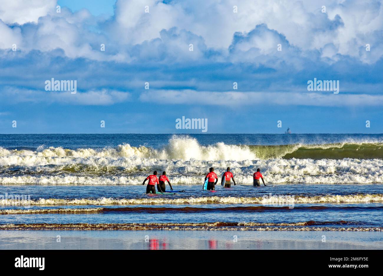 Lossiemouth East Beach Moray coast Scotland five surfers in red from ...