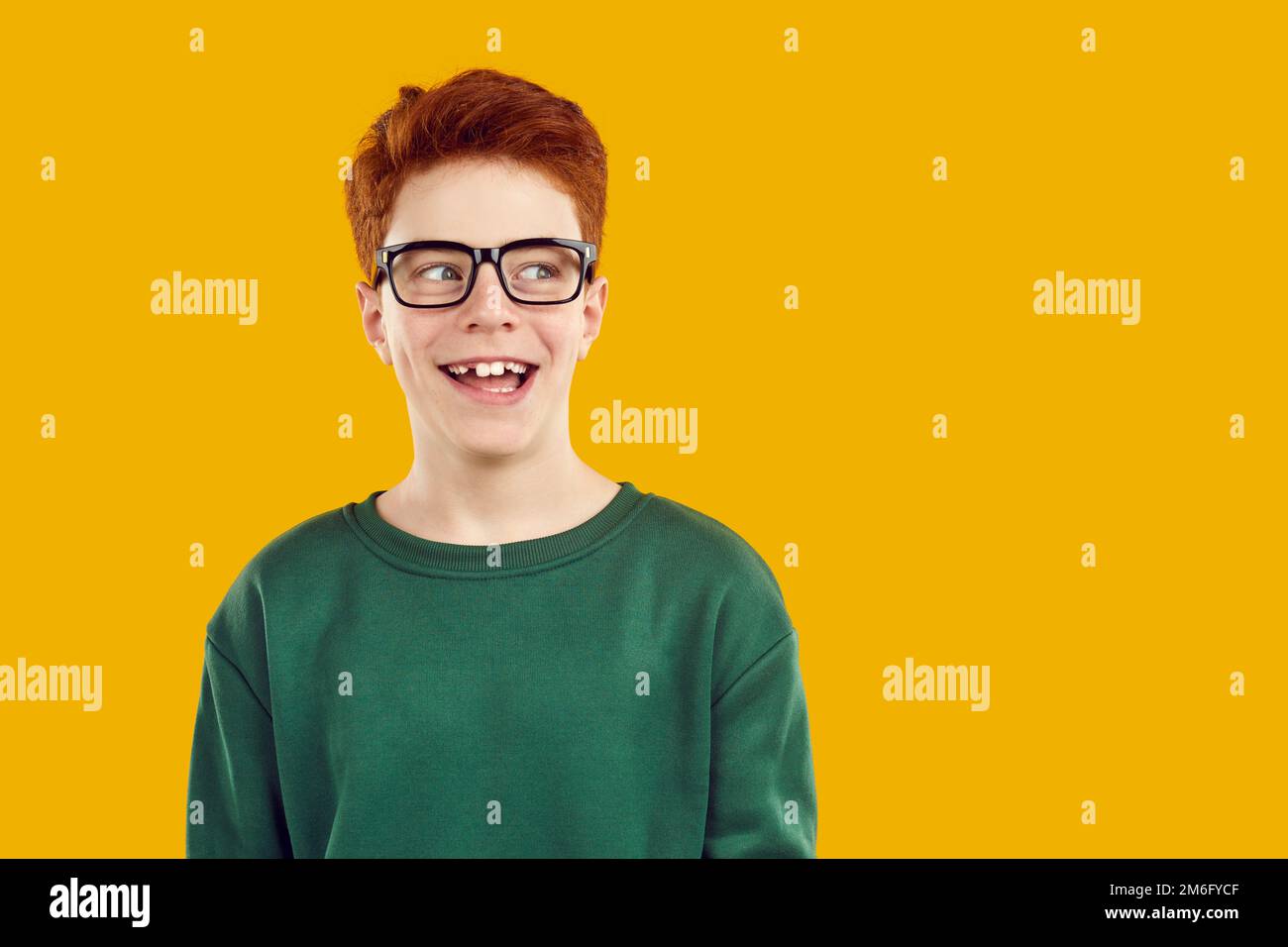 Portrait happy smiling red-haired confident boy in transparent glasses ...
