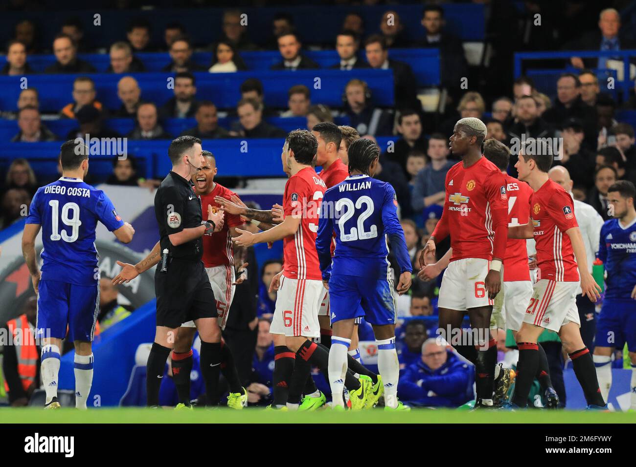 Manchester United players surround the referee as Ander Herrera of ...