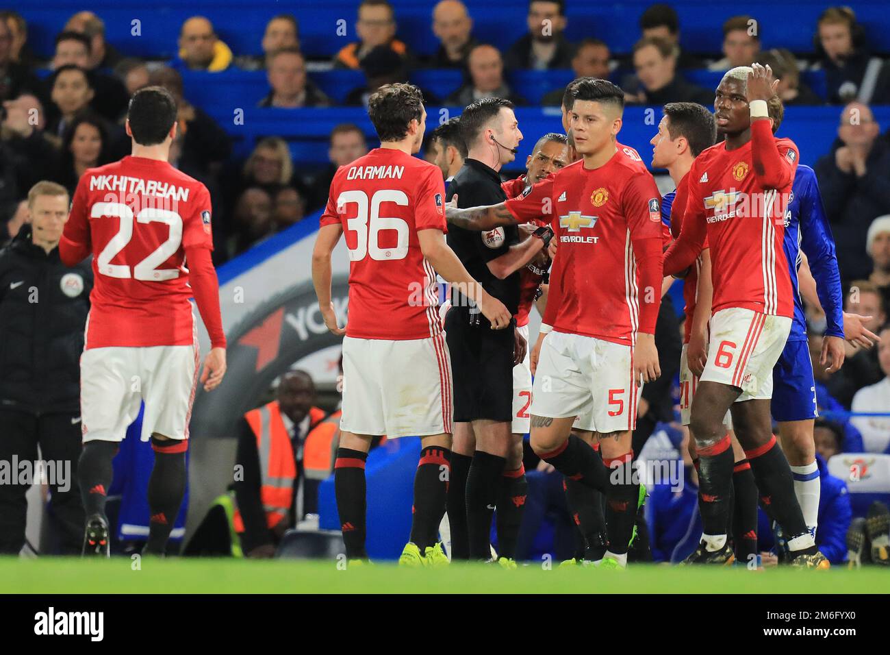Manchester United players surround the referee as Ander Herrera of ...