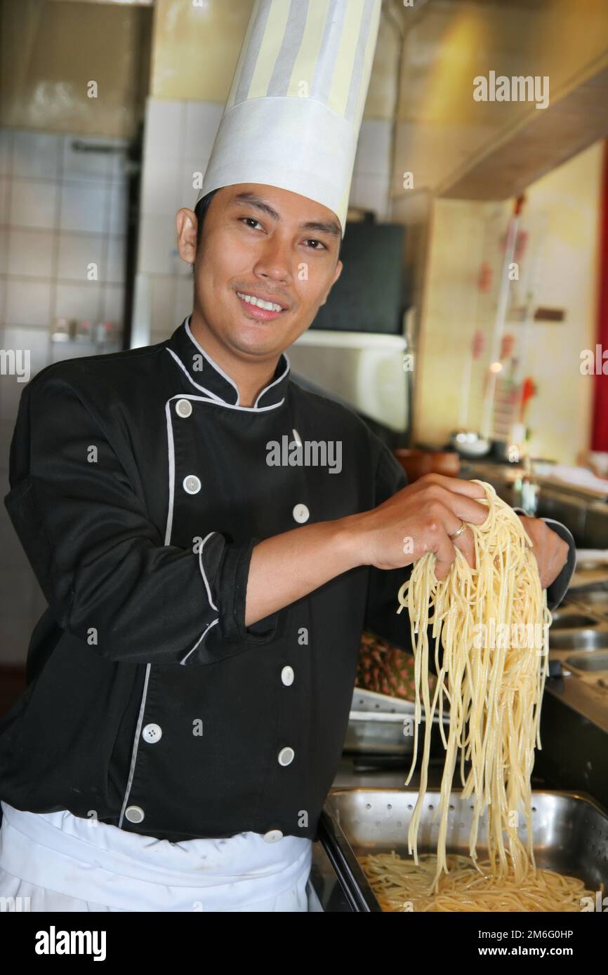 chef confidence smiling in uniform showing spaghetti at work Stock ...