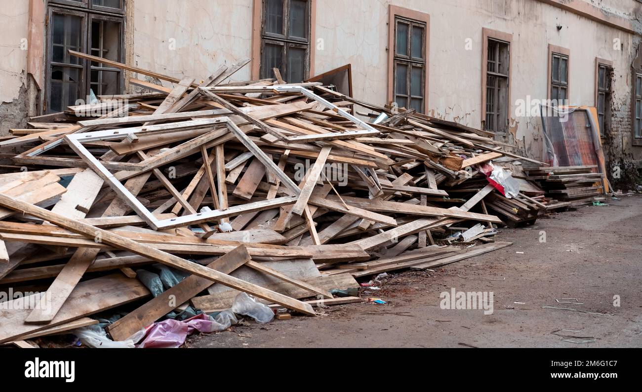 Heap of old broken timber planks construction garbage on street in town ...