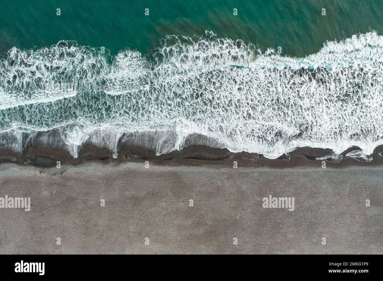 Aerial view of chilean ocean with black snd beach. Top view from drone ...