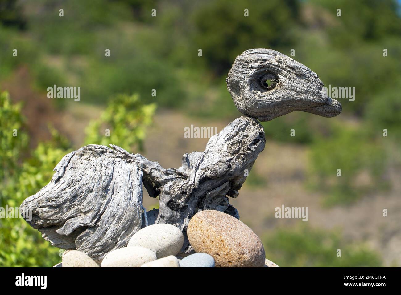 A sculpture made of stones and wood in the form of a bird in a nest ...