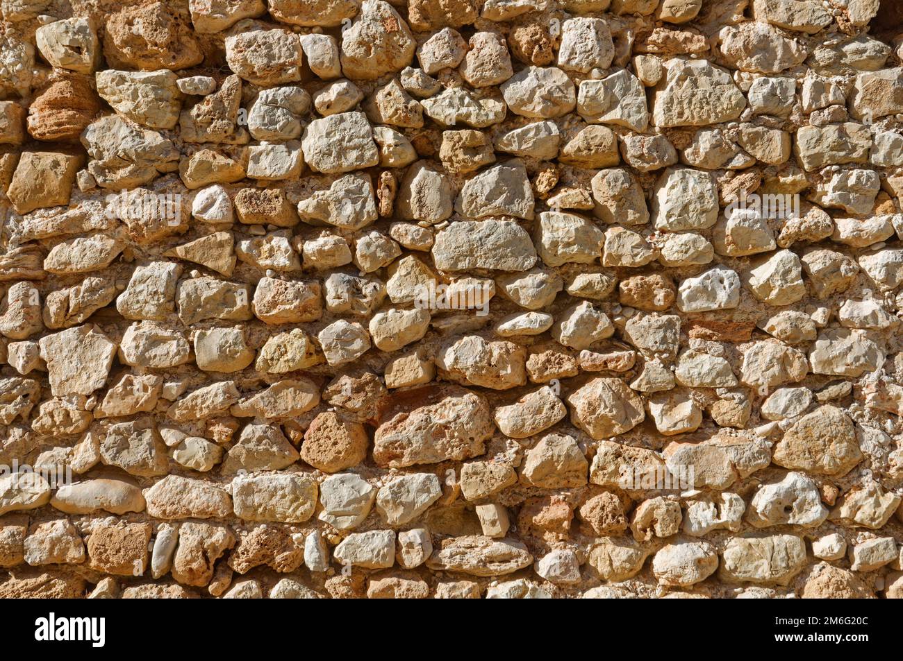 A rough stone wall texture background at the sunlight Stock Photo - Alamy