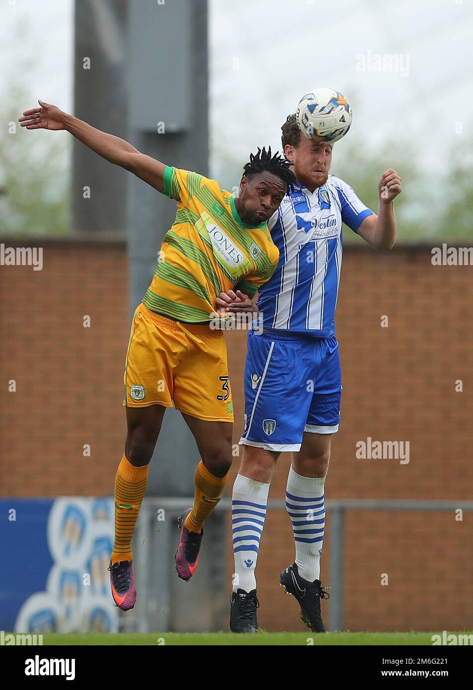 Tom Eastman of Colchester United beats Nathan Smith of Yeovil Town ...