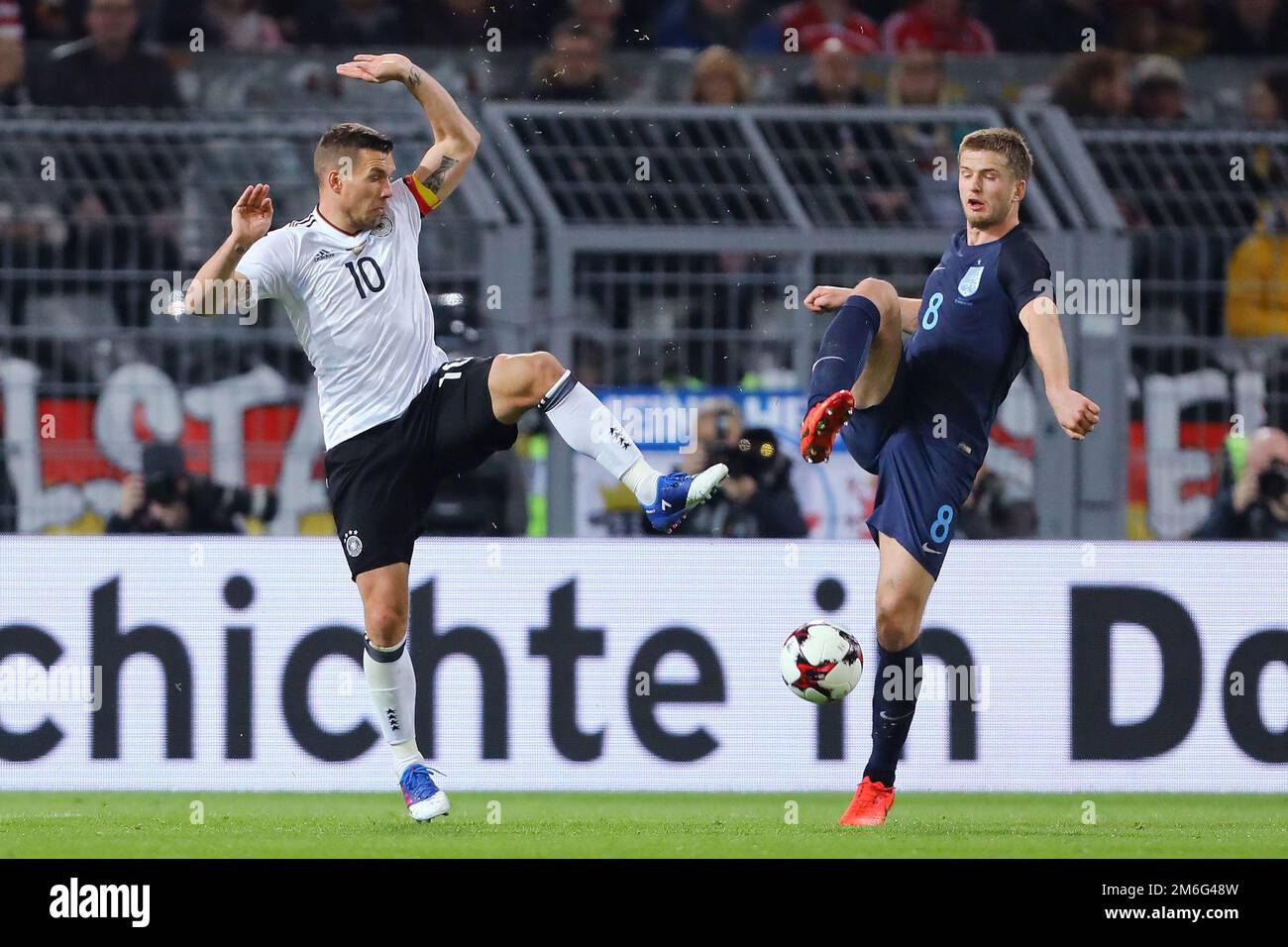 Lukas Podolski of Germany and Eric Dier of England battle for ...