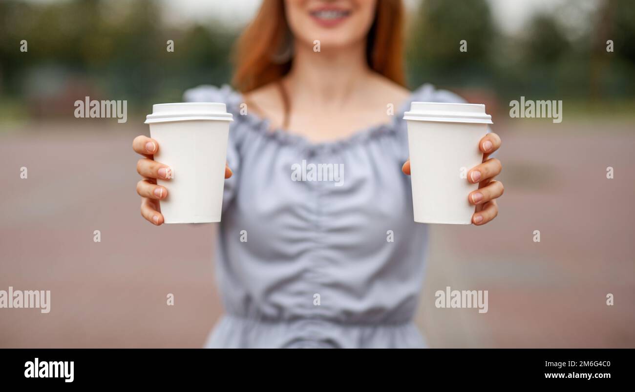 Two white paper cup with coffee in woman hand. Time for drink coffee ...