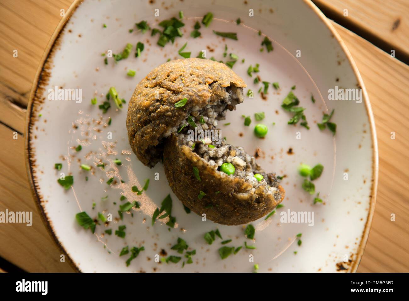 Arancini are a specialty of Sicilian cuisine. They are stuffed breaded ...