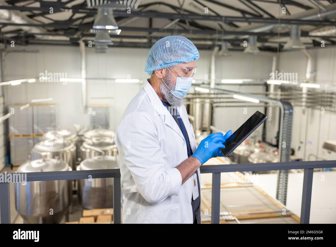 Brewer using a digital device at a beer plant Stock Photo - Alamy