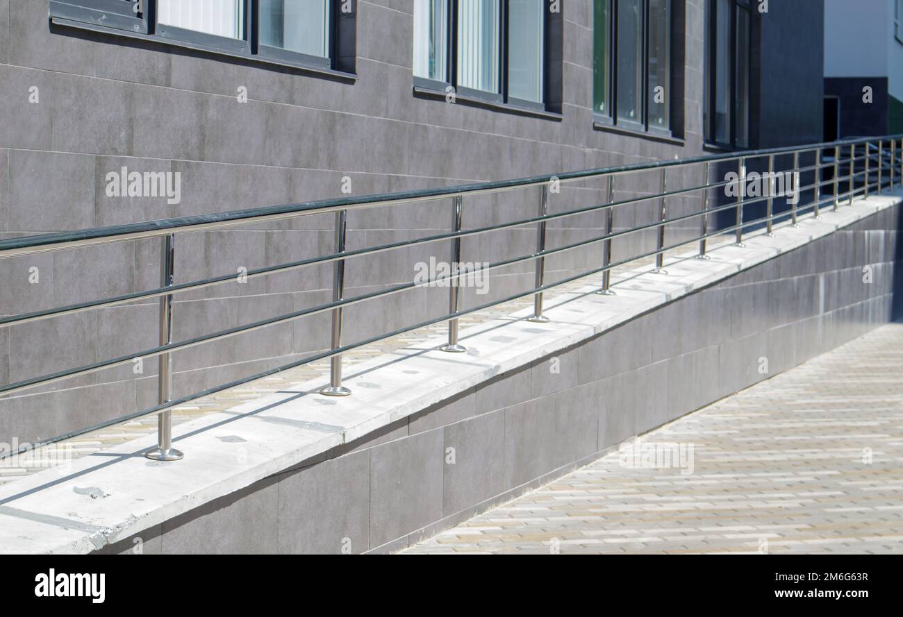 A ramp with stainless steel handrails for wheelchairs, bicycles and ...