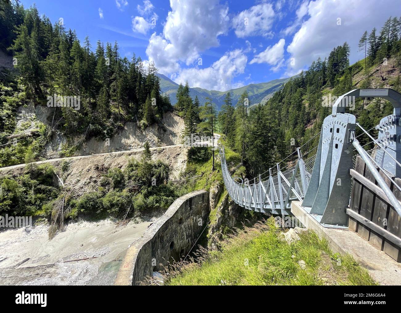 Suspension bridge over dam in the Austrian mountains Stock Photo - Alamy