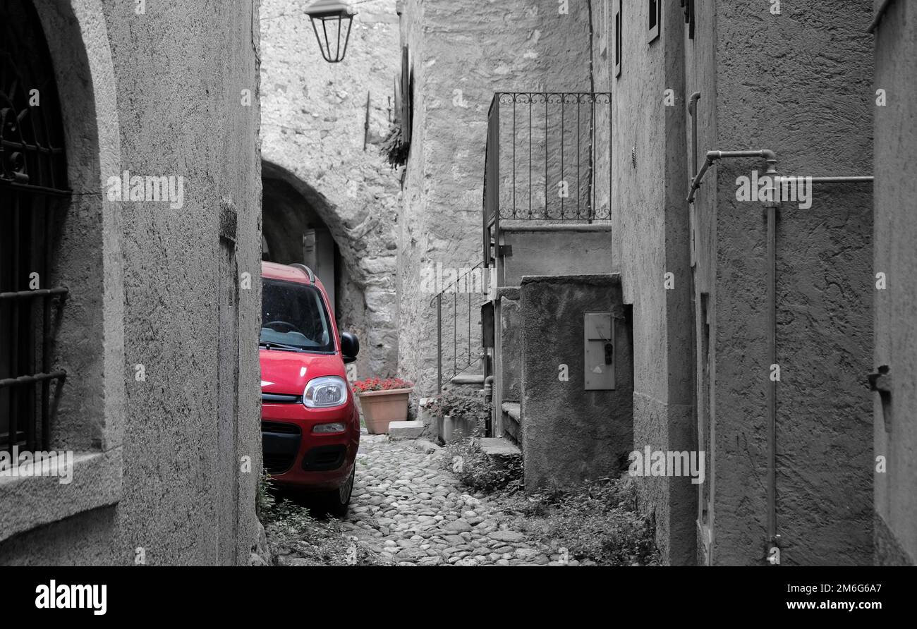 Monocolor red car in black and white street Stock Photo - Alamy