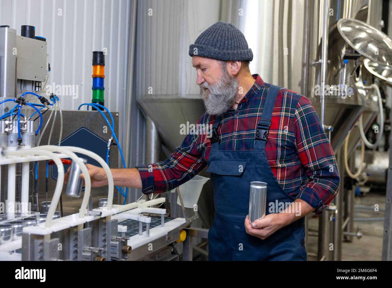 Calm concentrated production operative working in the factory Stock ...