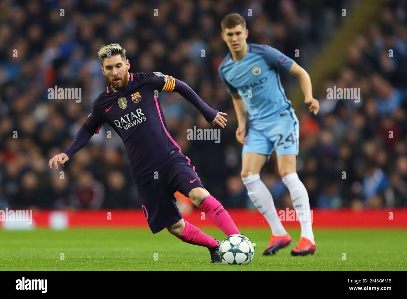 Lionel Messi of Barcelona gets away from John Stones of Manchester City ...