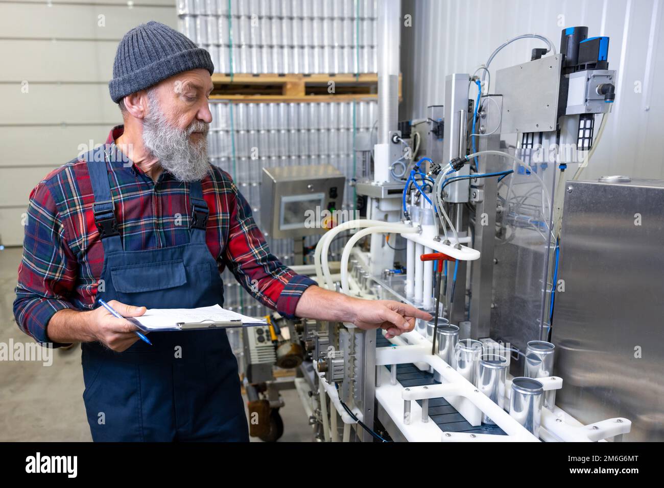 Production operative controlling the operation of the liquid filling ...