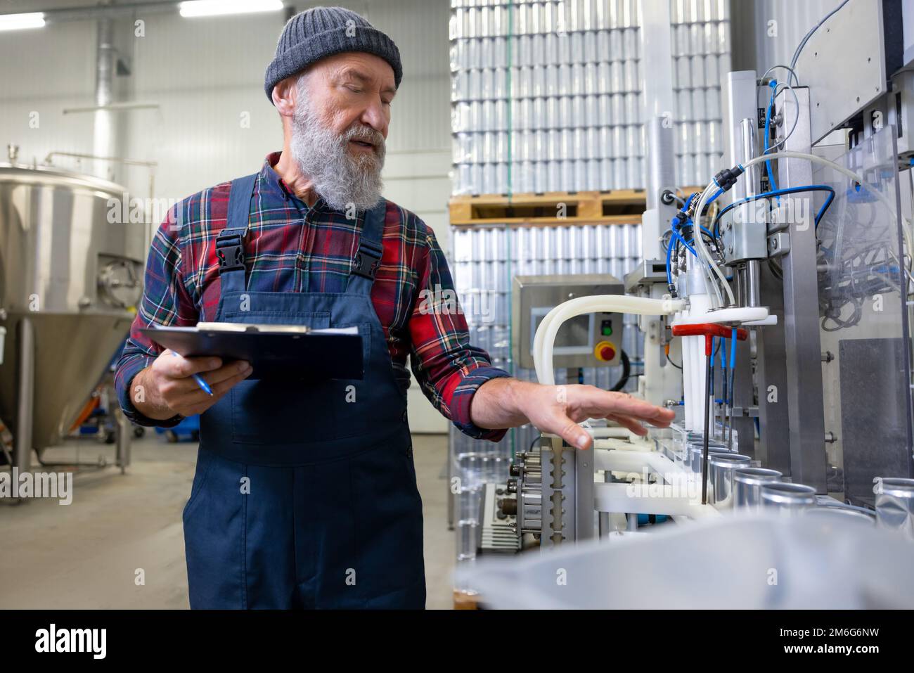 Production operative monitoring the beverage canning process Stock ...