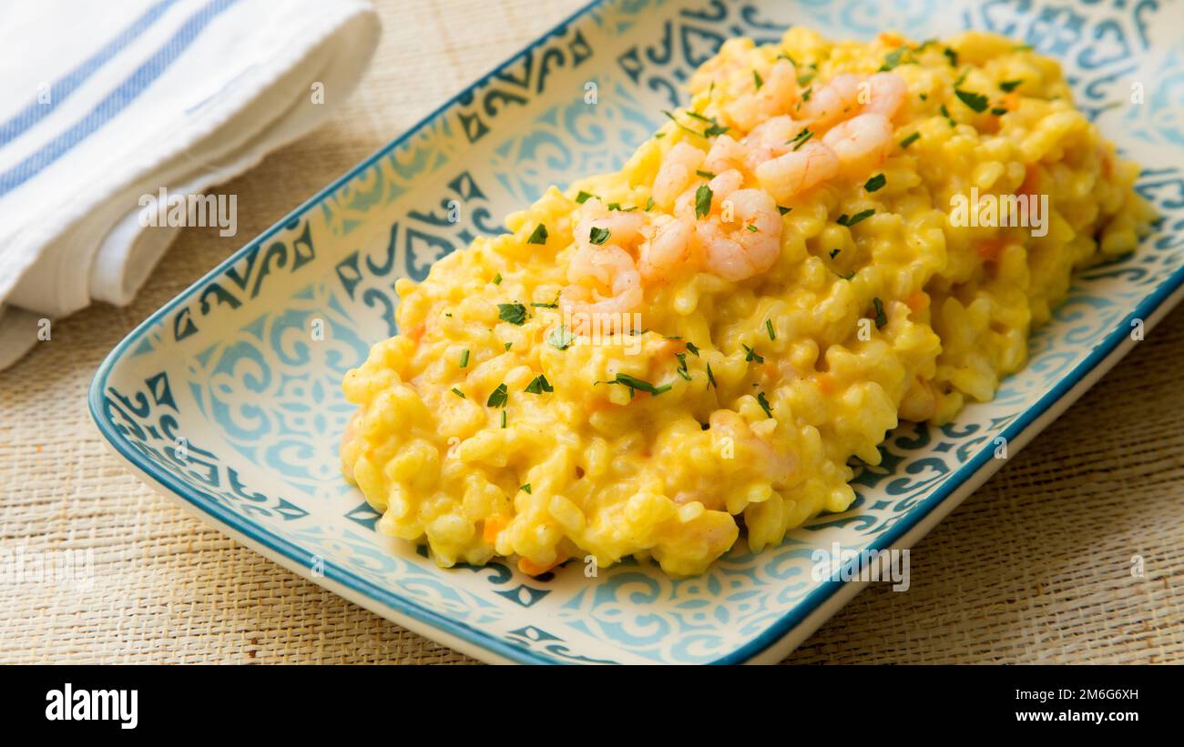 Risotto with shrimps and carrot and curry. Risotto is a northern ...