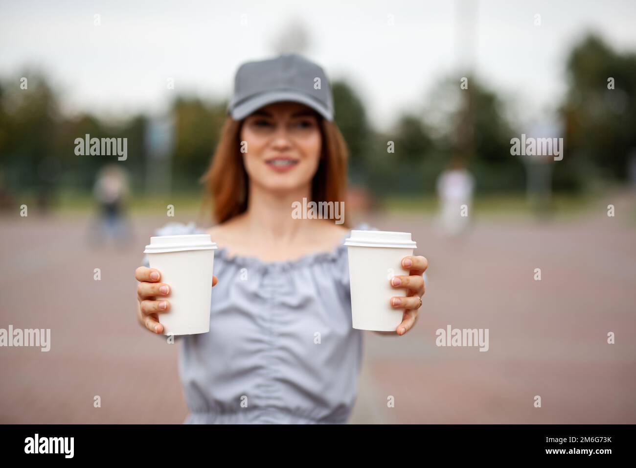 Two white paper cup with coffee in woman hand. Time for drink coffee ...