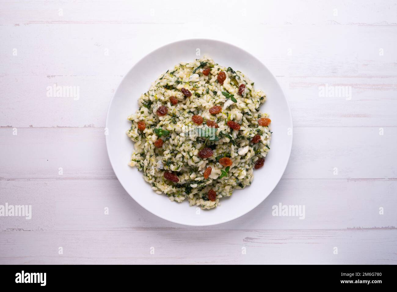 Risotto with spinach and raisins. Risotto is a northern Italian rice ...