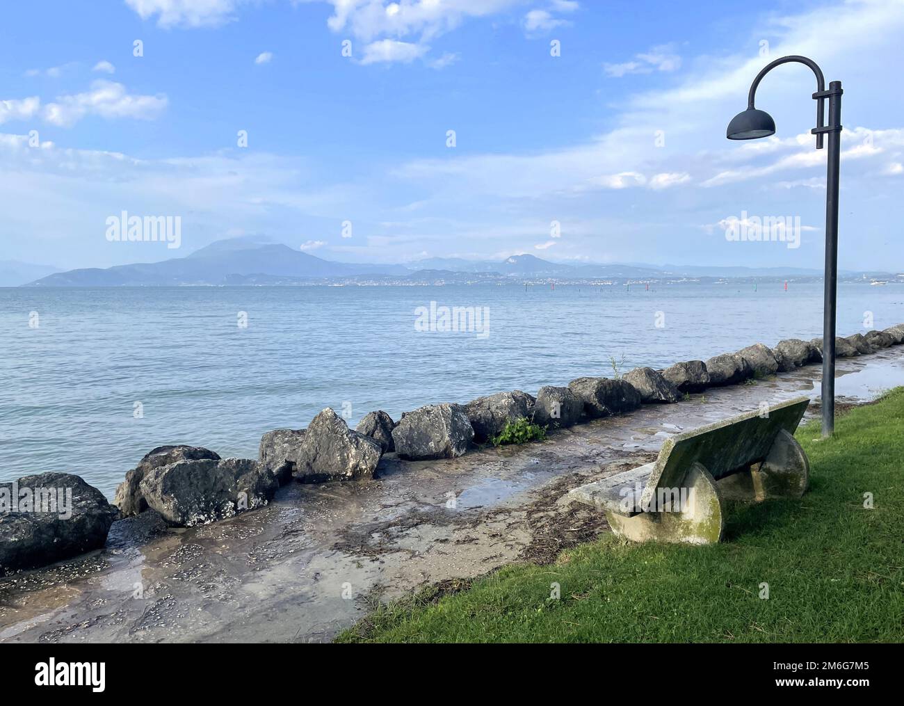 Water of lake garda in italy surrounded by mountains Stock Photo - Alamy