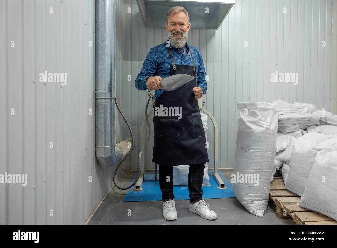 Mature man working in a small brewery and looking contented Stock Photo ...