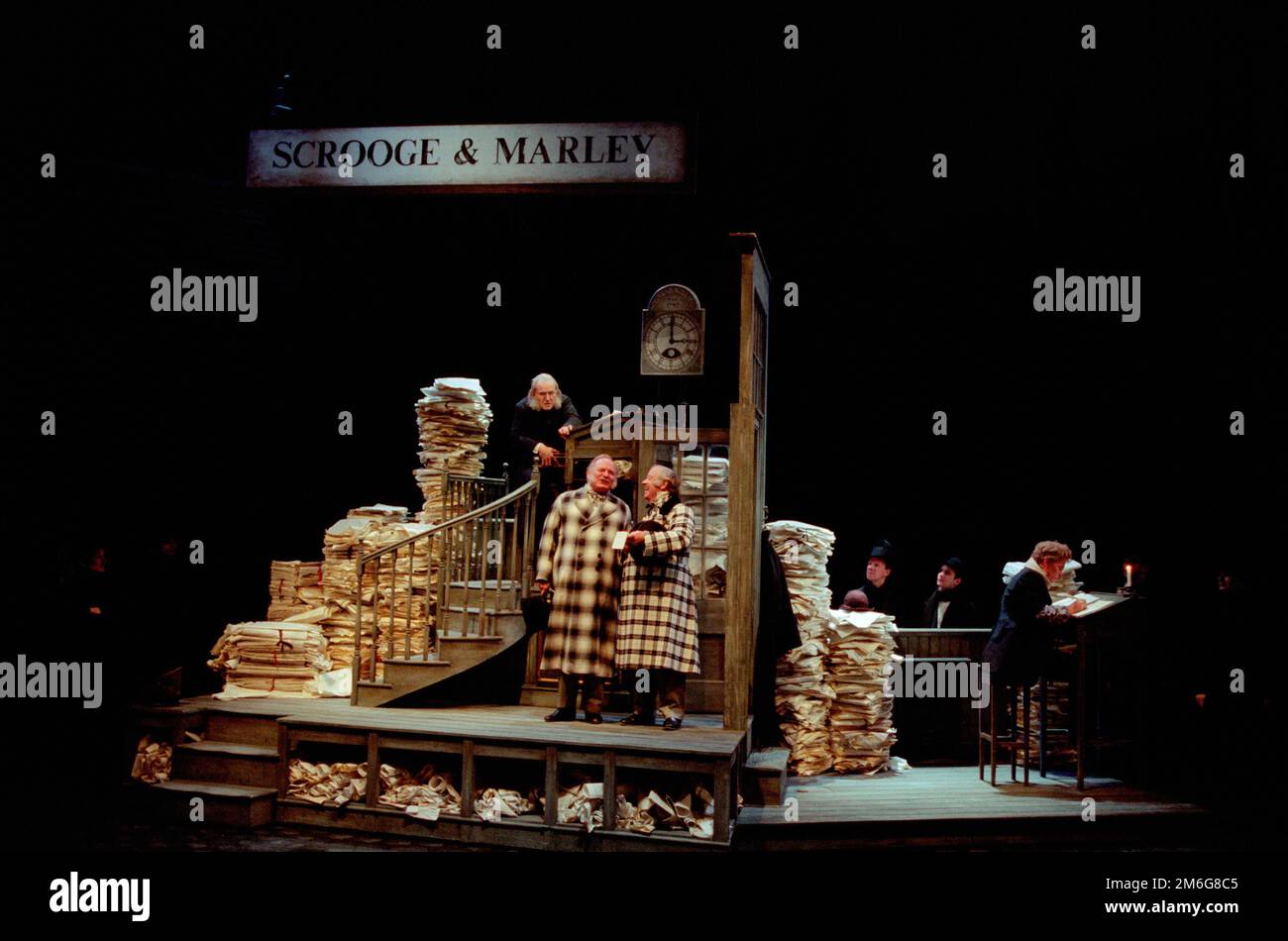 centre, at desk: Clive Francis (Ebenezer Scrooge) right: Paul Greenwood ...