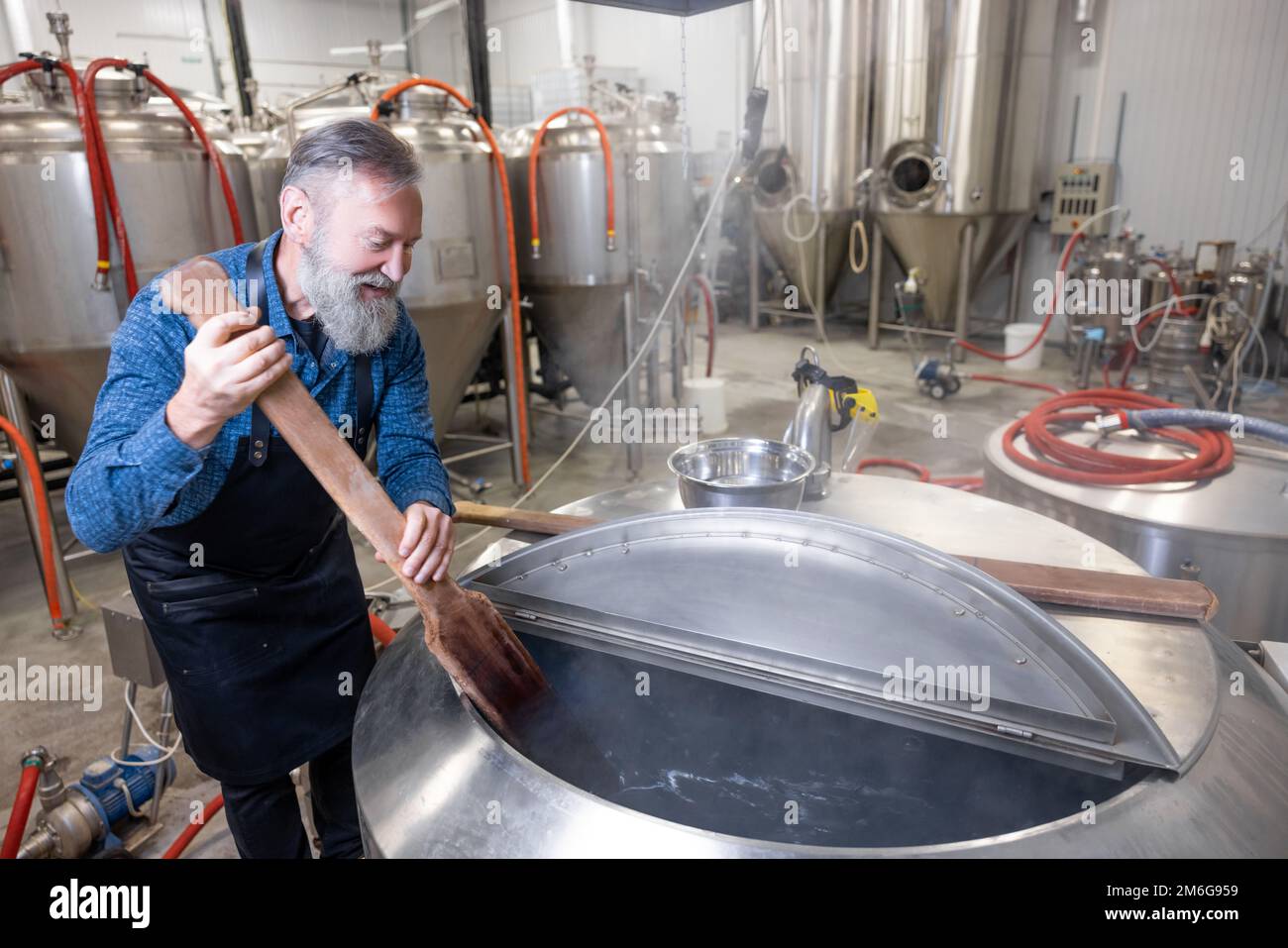 Beer brewer stirring hi-res stock photography and images - Alamy