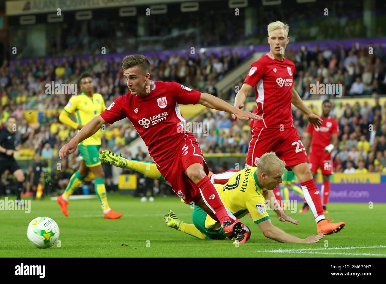 Steven Naismith of Norwich City goes down in the penalty area as Joe ...