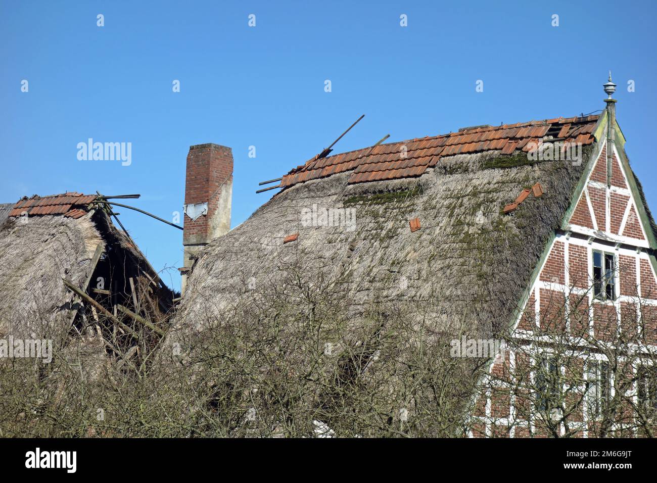 Heavily damaged thatched roof of a half-timbered house Stock Photo - Alamy