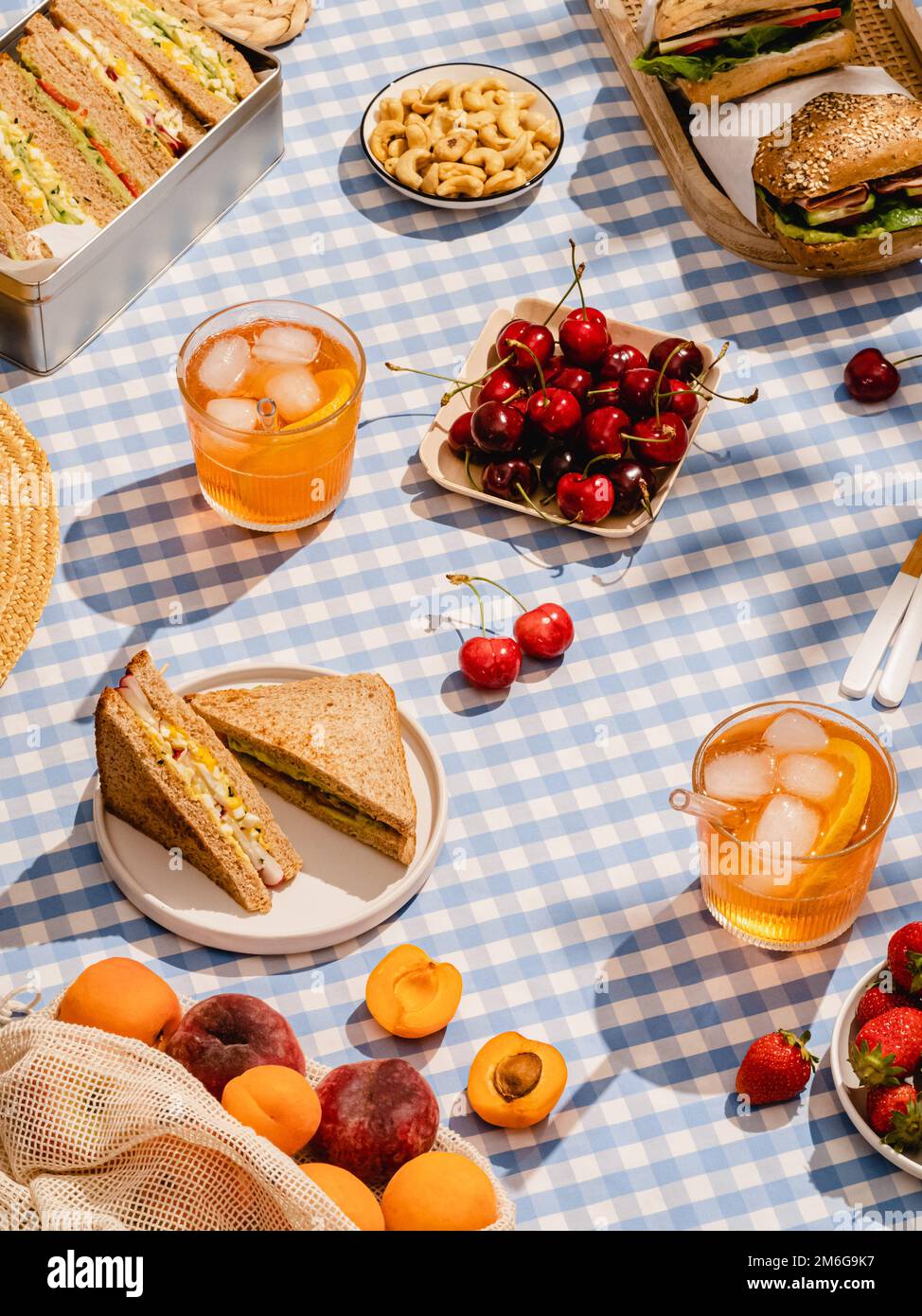 Picnic set with fruit, cheese, toast, honey, wine with a wicker basket ...