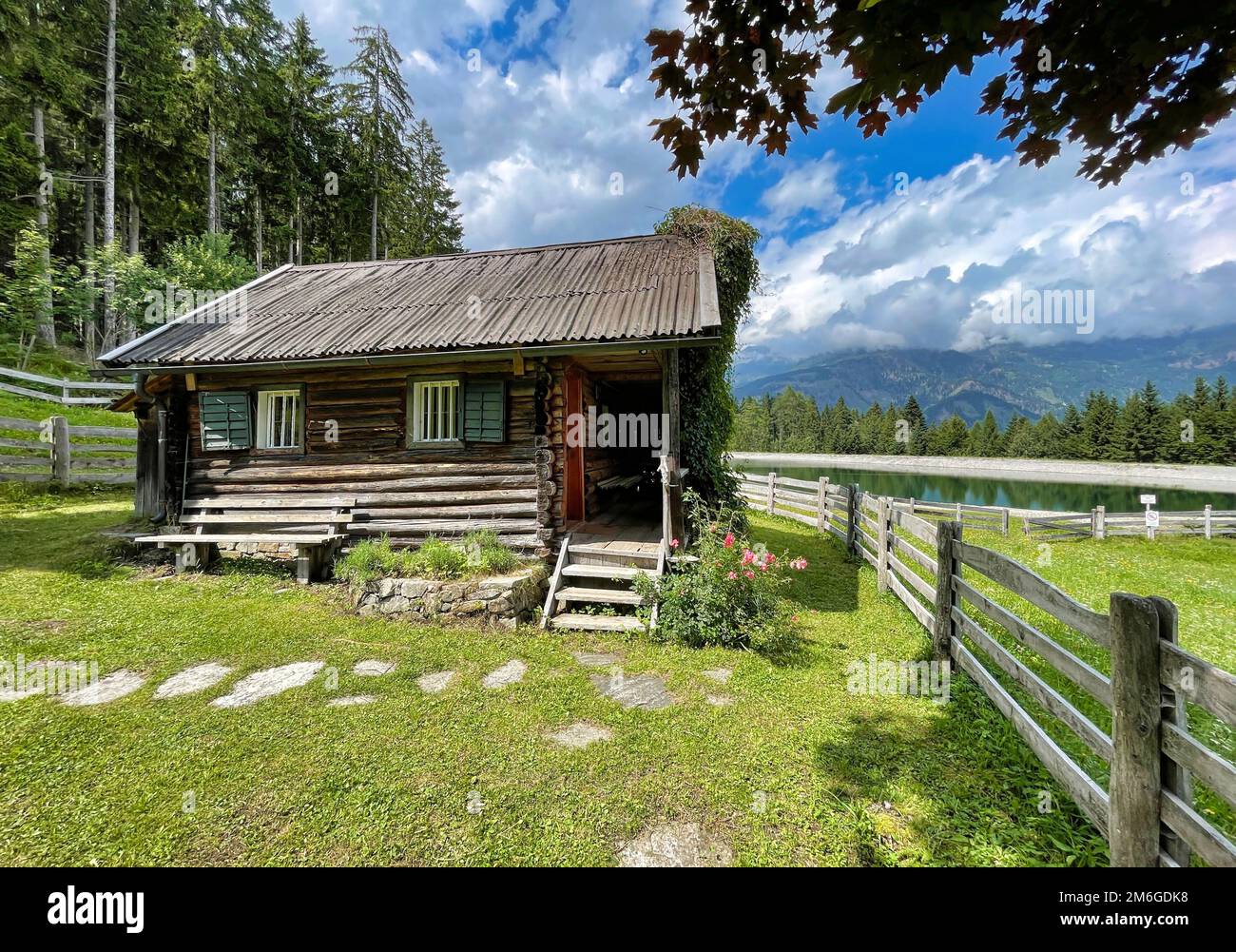 Cabin in the mountains next to a lake in the austrian alps Stock Photo ...