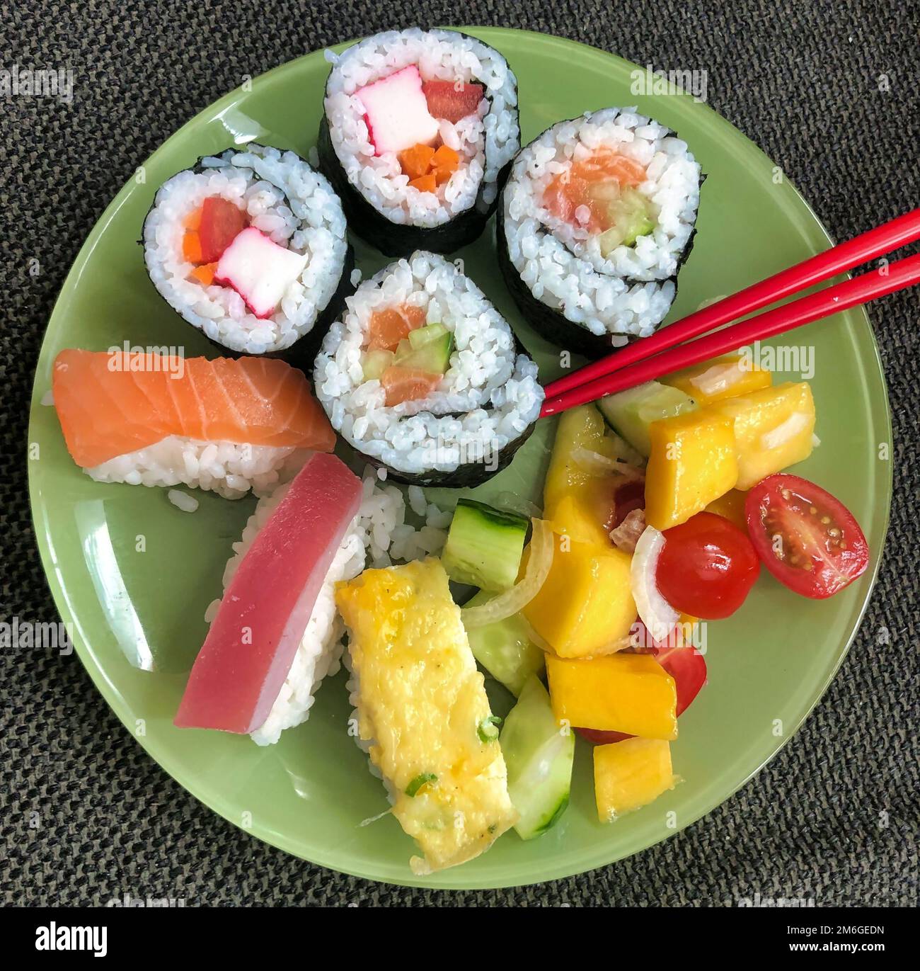 Green sushi plate with green sticks and fruit Stock Photo - Alamy