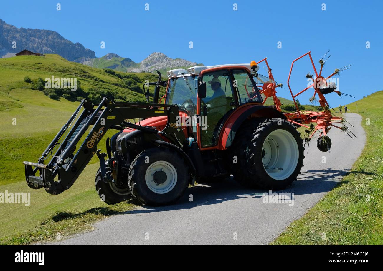 A tractor working in the fields high in the mountains Stock Photo - Alamy