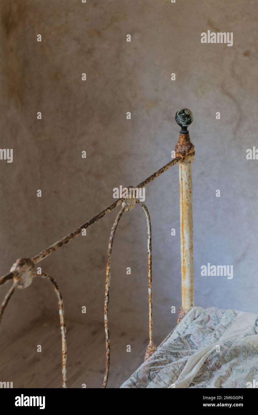An old bed with a rusty metal bed frame Stock Photo - Alamy