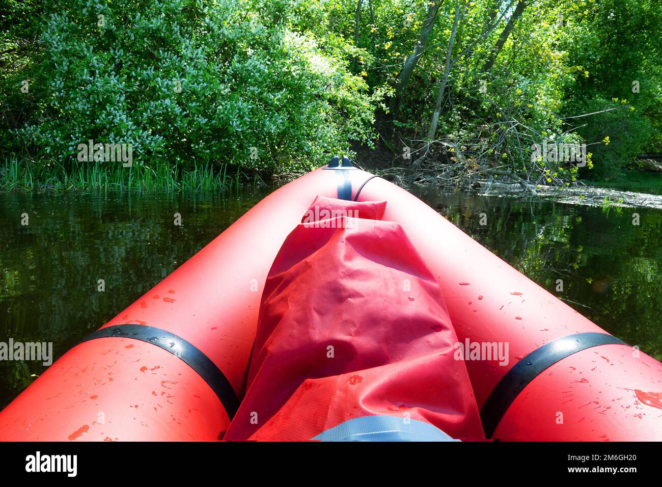 Travel on a red inflatable kayak on the spring river Stock Photo - Alamy