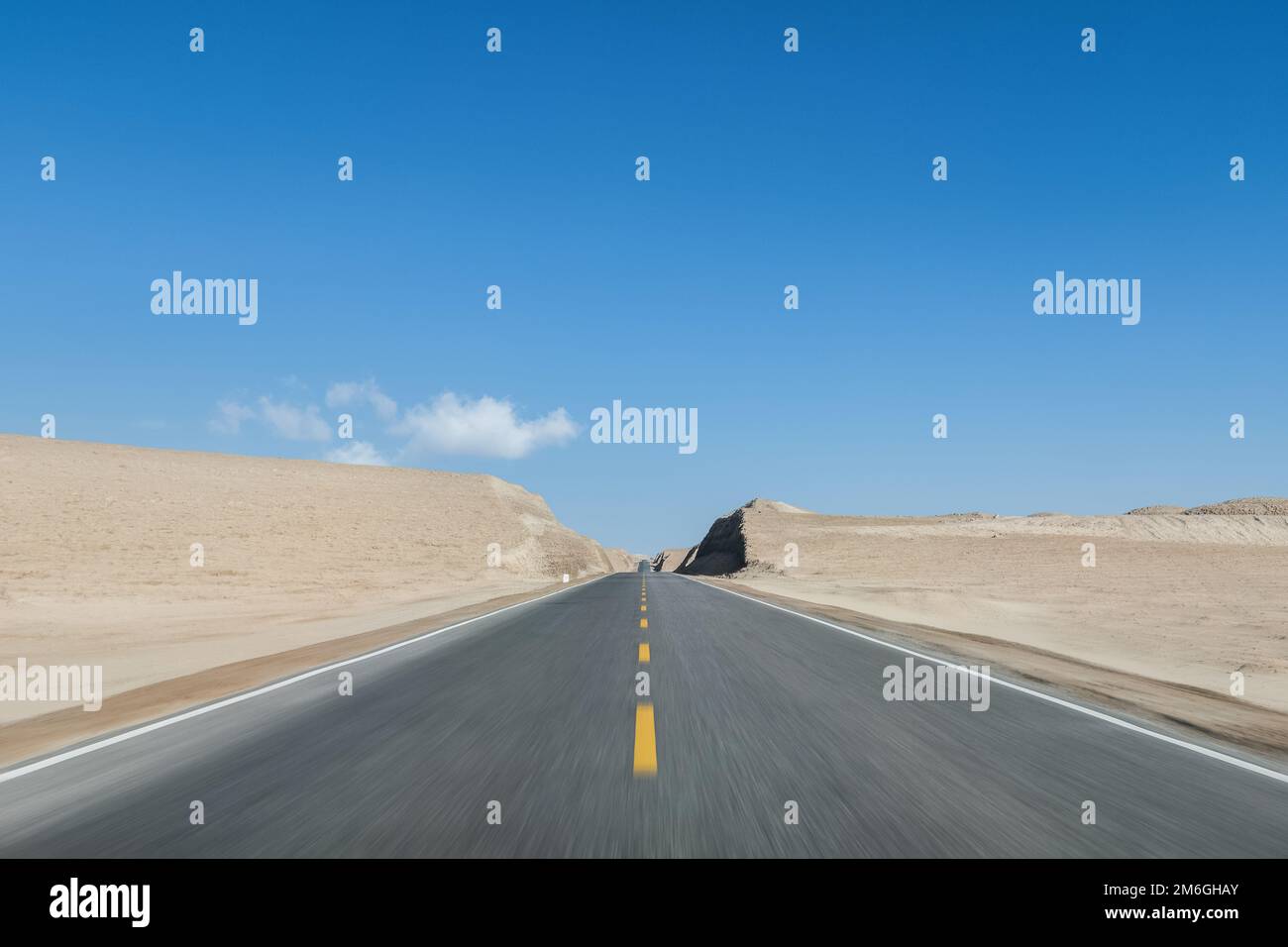 Straight road through the wind erosion landform Stock Photo - Alamy