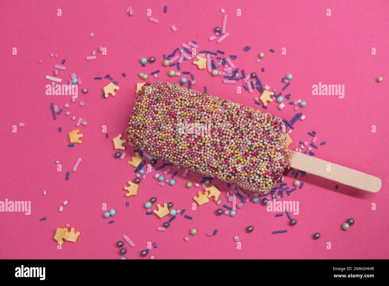 Ice cream on stick with colorful sprinkles Stock Photo - Alamy