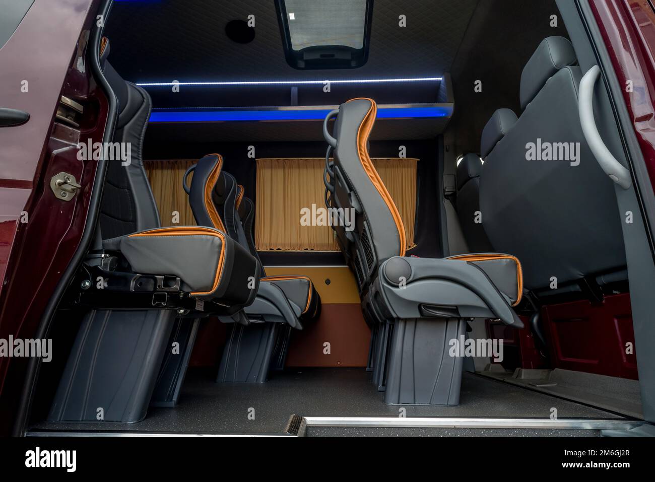 comfortable passenger bus interior with upholstered seats; individual ...