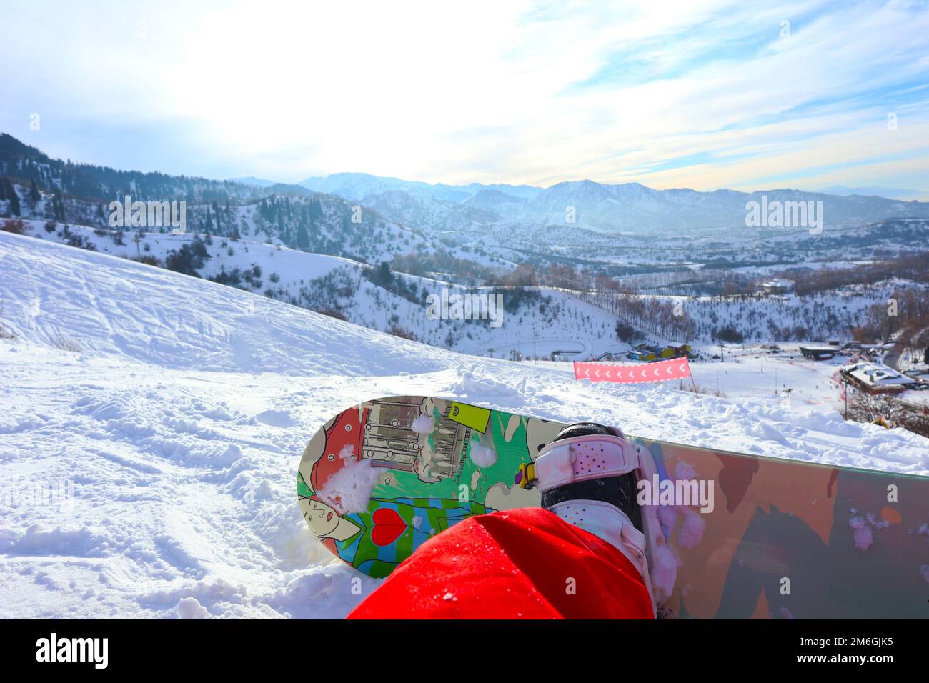 snowboarding on the background of a mountain resort Stock Photo - Alamy