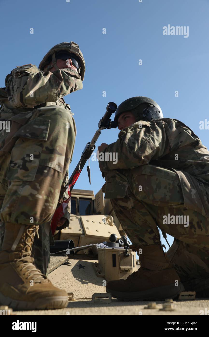 From left, U.S. Army Sgt. 1st Class Michael Metcalf, a gunnery coach ...