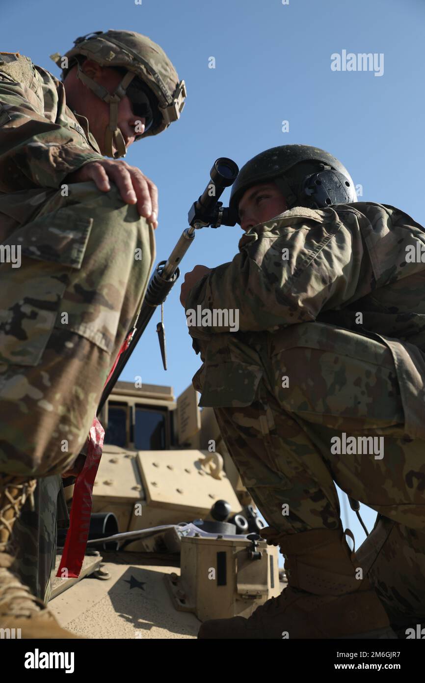 From left, U.S. Army Sgt. 1st Class Michael Metcalf, a gunnery coach ...