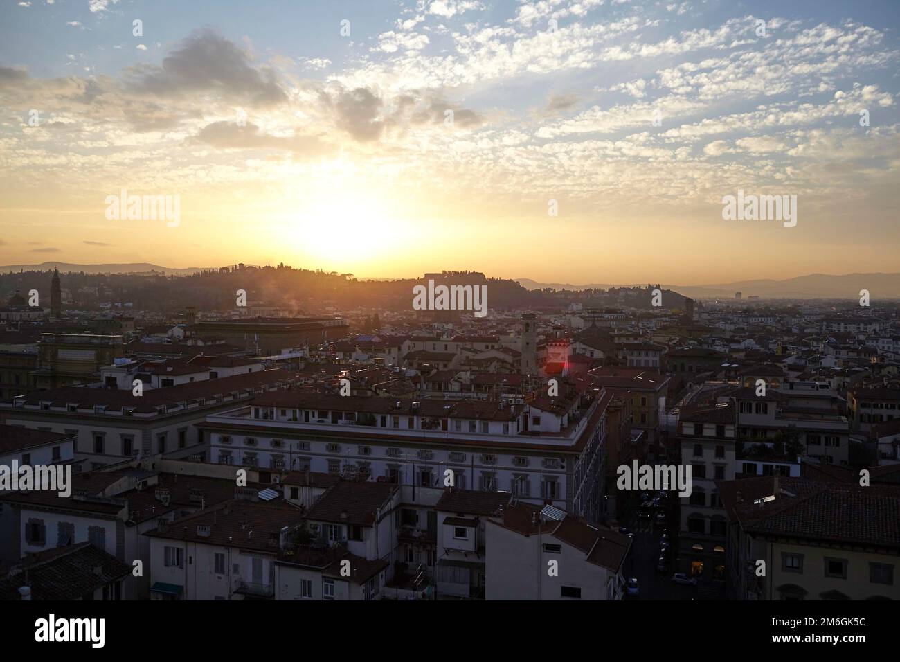 A view of the sun setting over Florence from above at dusk Stock Photo ...