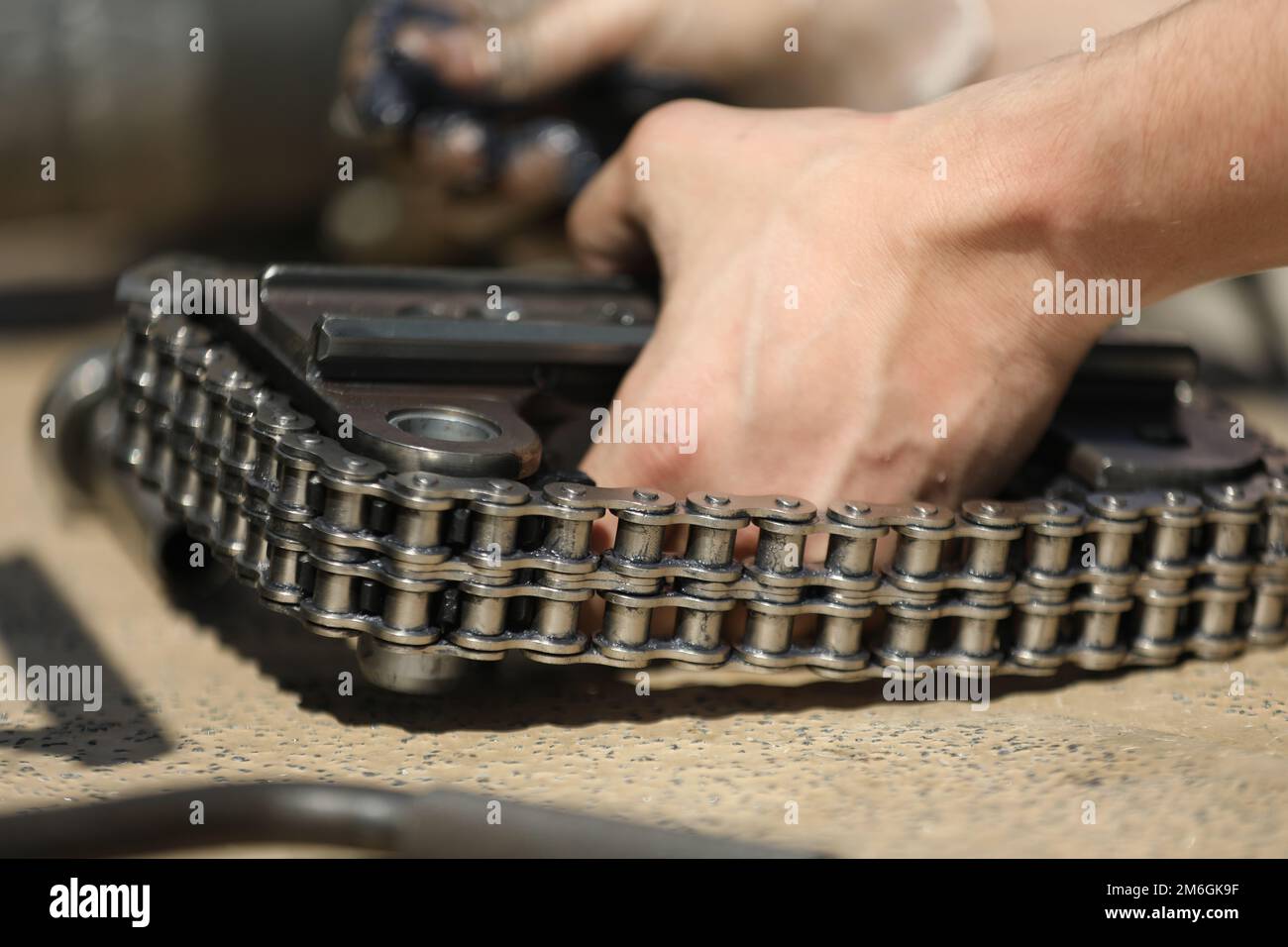 U.S. Army soldier greases the bolt and track of the Bradley M242 25mm ...
