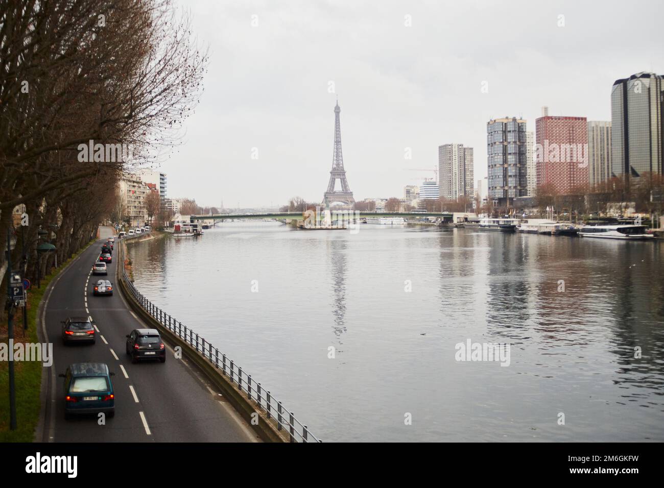A view of the Eiffel Tower from across the river seine on a cold winter ...