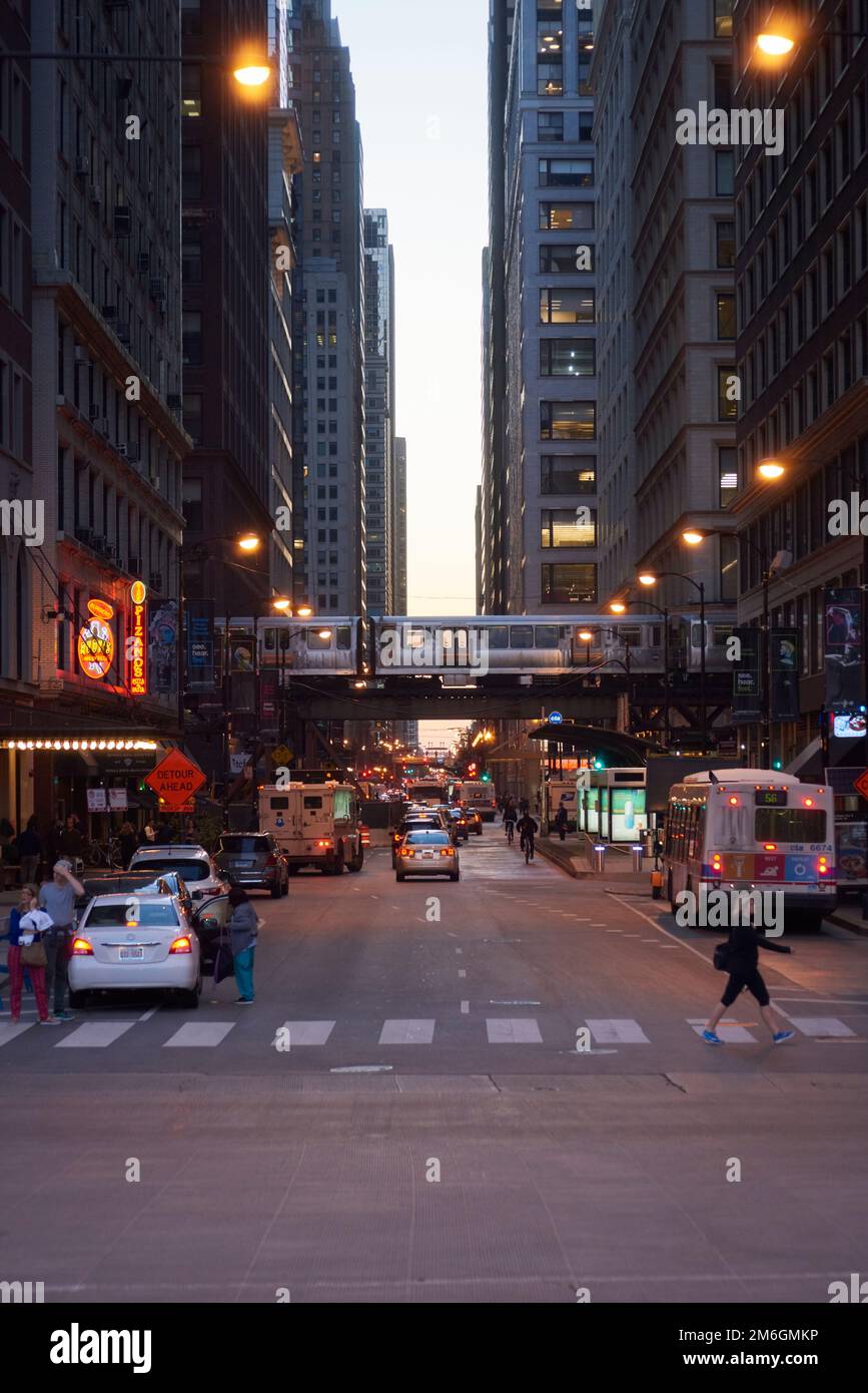 a view down West Madison Street in Chicago as the L train crosses at ...