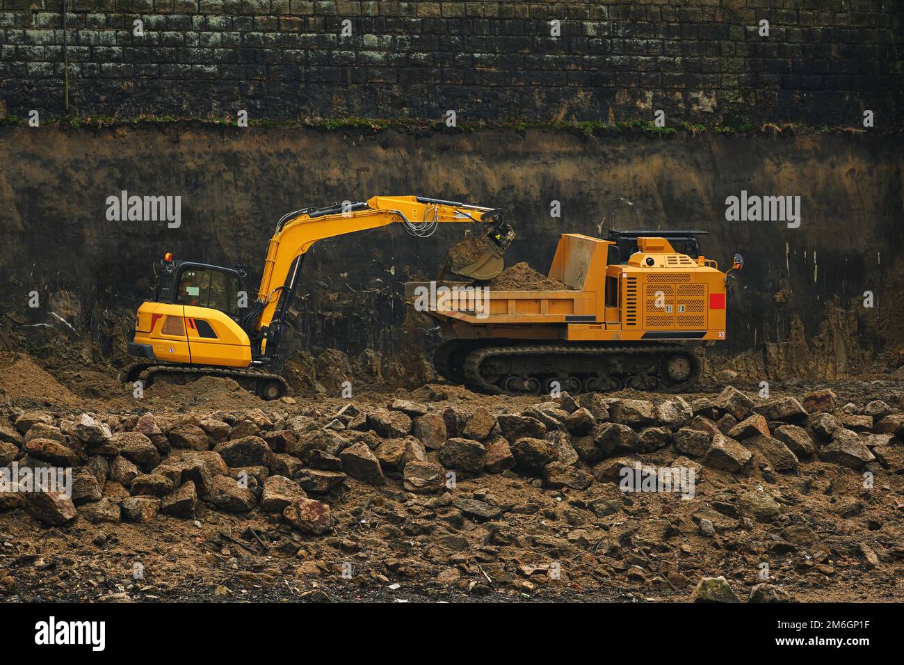 The modern excavator performs excavation work on the construction site ...